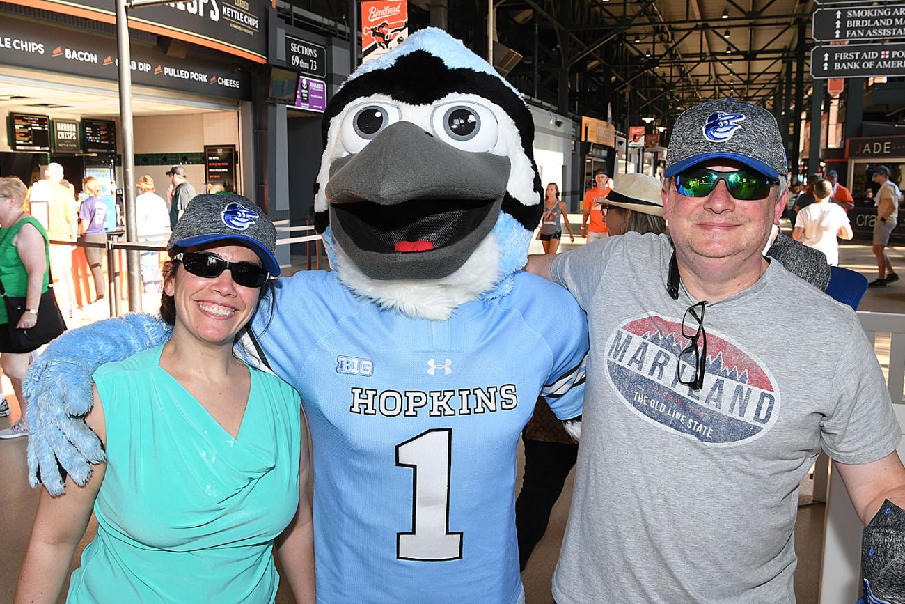 Hundreds of blue-hatted fans cheer on the Os at Hopkins Night at Camden ...